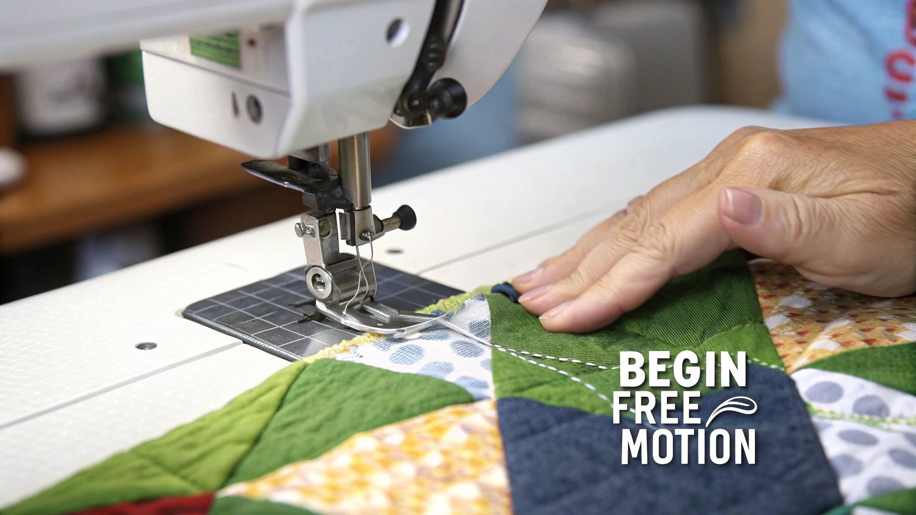A person's hand guides a colorful quilt under a sewing machine needle ...